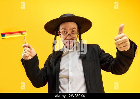 Portrait of emotional, excited Jewish man in black suit, yarmulke ...