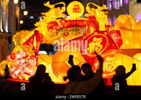 People take pictures with a decorations New Year on display at shopping ...