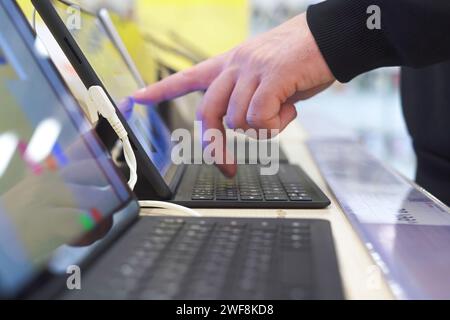 Buyer checking laptops in a computer store Stock Photo - Alamy