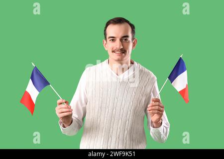 Handsome man with flags of France on pink background. Bastille Day ...