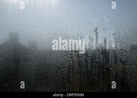 Closeup of heavy water condensation on window glass during a winter ...