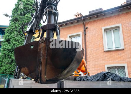 Close up image of dumping asphalt by and excavator Stock Photo - Alamy