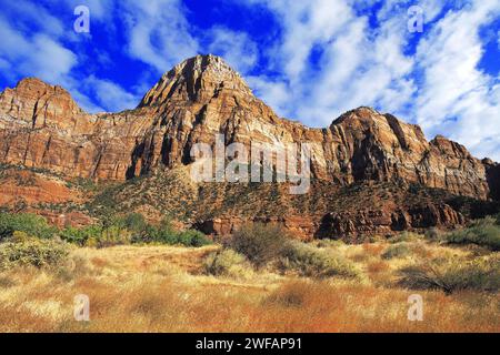 Rock peaks at the entrance to Zion Canyon, with red rock-faces and blue ...