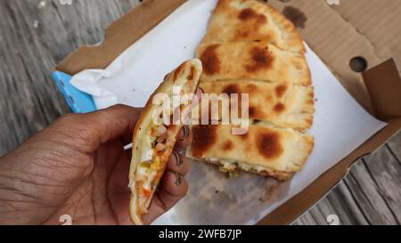 Italian dish Calzone in box, Veg calzone stuffed with cheese ...