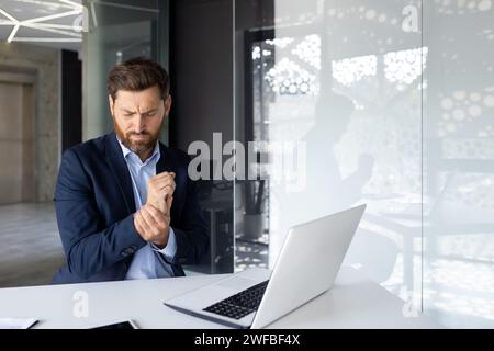 man from overstrain holds his hand on the nose or forehead on the ...