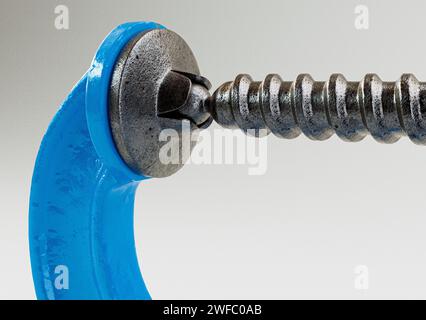 A blue vintage styled G-clamp tool on an isolated white studio ...