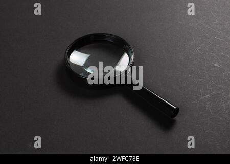 magnifying glass on black texture background with shadow Stock Photo ...