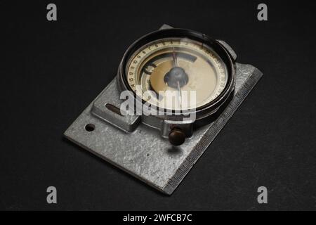 Old geological compass on dark background close up Stock Photo - Alamy