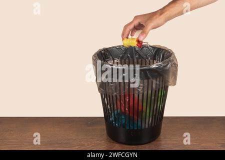 Apple core is thrown into trash, food waste.On white background isolate ...