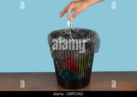 throw glasses in trash bin, glasses in hand in front of trash can ...