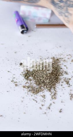 person puts weed in scraper Stock Photo - Alamy