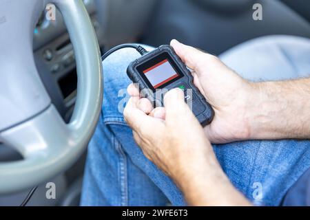 Using diagnostic car code reader to erase error codes and turn off ...