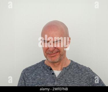 Candid portrait of mature bald man laughing emotionally with eyes ...