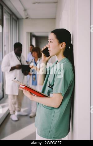 Asian women doctor talking phone consultation medical professional ...