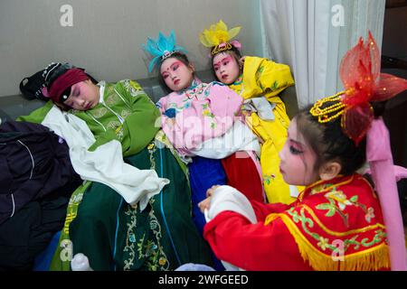 Children are taking a nap during a Peking Opera performance in a ...