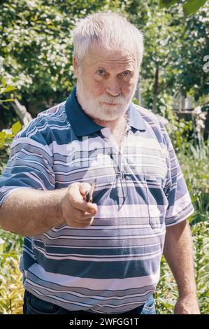Hand holding a knife in hand on a white background Stock Photo - Alamy
