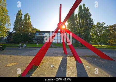 red sculpture made of steel profiles L'Allumé at river Rhine, pointing ...