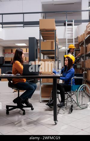 Warehouse order picker giving manager package ready to shipment. Asian ...