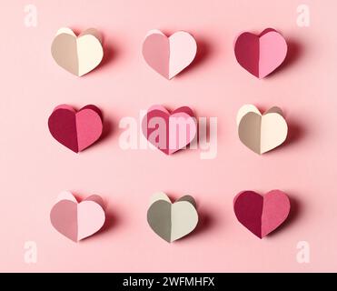 Pink color heart shaped paper in hand as love concept Stock Photo - Alamy