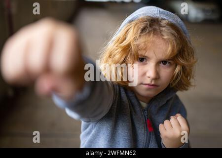 Kid boy in hoodie fighting. Little kid boy fighting outside. Angry ...