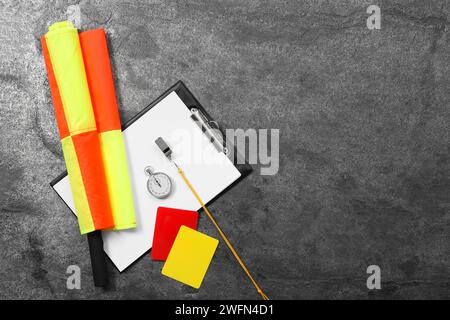 Different referee equipment on grey table, top view. Space for text ...