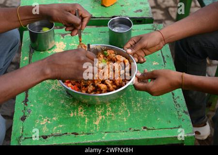 Locals enjoying egg & tomato sauce Dabo firfir in a s mall restaurant ...