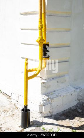 Gas entry point to a residential building. Gas pipes with valve on the ...