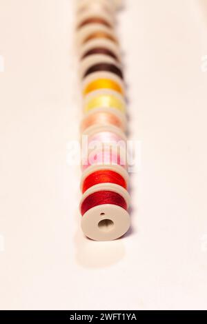 colorful sewing threads on bobbins isolated on white Stock Photo - Alamy