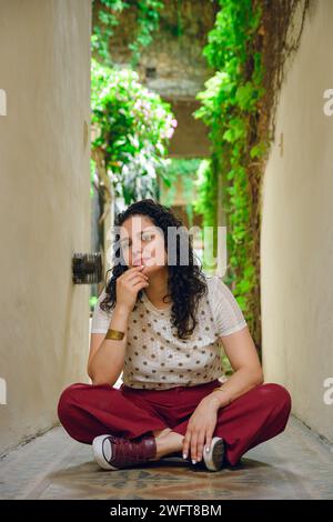 Image of attractive thinking woman with curly red hair holding exercise ...