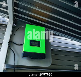 Solar inverter mounted on the wall of a residential home. Solar energy ...