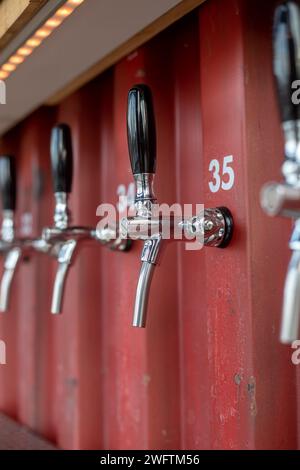 many draft beer handles in a row Stock Photo - Alamy