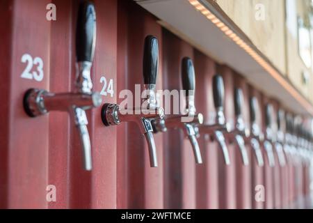 many draft beer handles in a row Stock Photo - Alamy