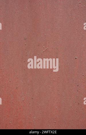 An old, uneven, metal surface with bumps covered with brown, red ...