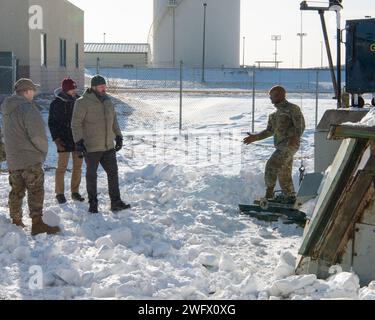 Col. Kenneth McGhee, 91st Missile Wing commander, shows members of the ...