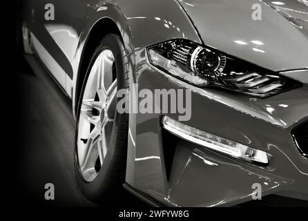 Front view of LED headlights sport car on black background, copy space ...