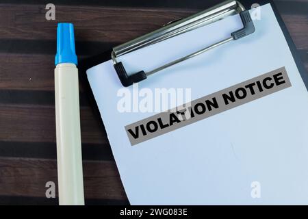 Violation Notice write on a paperwork isolated on Wooden Table Stock ...