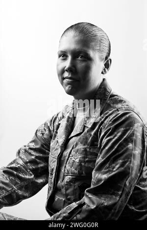 A Caucasian, female Air Force Security Forces Airman in uniform gives ...