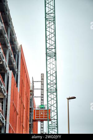 Hoists moving up and down side of building under construction Stock ...