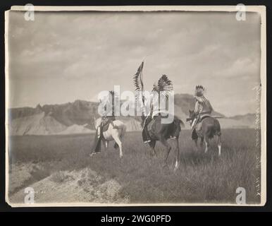 A Sioux war party, 1905. Photograph shows three warriors, wearing ...