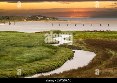 Tidal marsh Sea Inlet sunset at low tide near Waren mill ...