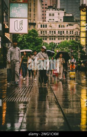 Overcrowded street Shanghai, China, rainy weather Stock Photo - Alamy