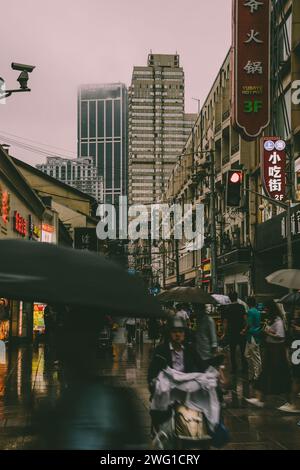 Overcrowded street Shanghai, China, rainy weather Stock Photo - Alamy