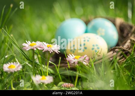 Easter eggs behind the pink flowers Stock Photo - Alamy