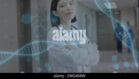 Image of dna strands over asian female nurse treating female patient ...