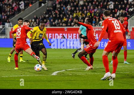 Dortmund's Jamie Gittens, left, in action against Heidenheim's Omar ...