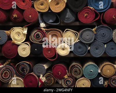 Colorful rolled rugs on display at a market stall Stock Photo - Alamy