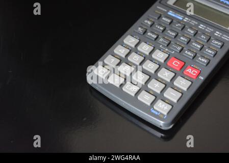 A gray calculator made of quality plastic with beautiful colors located ...