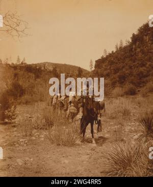 Apache land, c1903. Three Apache people riding pack horses make their ...