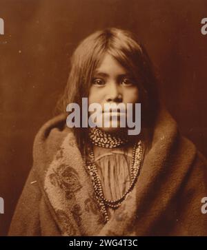 An Apache girl, head-and-shoulders portrait, facing front, wearing bead ...