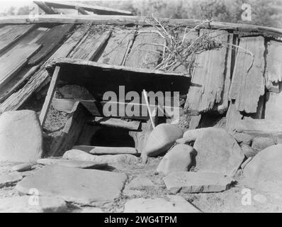 Entrance to a Yurok Sweat-house, c1923. Sheltered hole in mound of ...